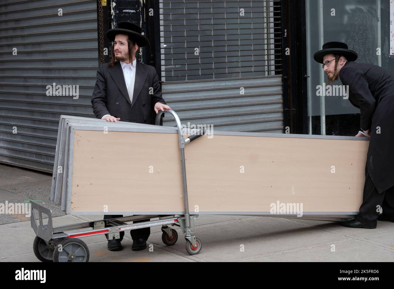 2 orthodox Jewish men transport building materials for their Sukkah in ...