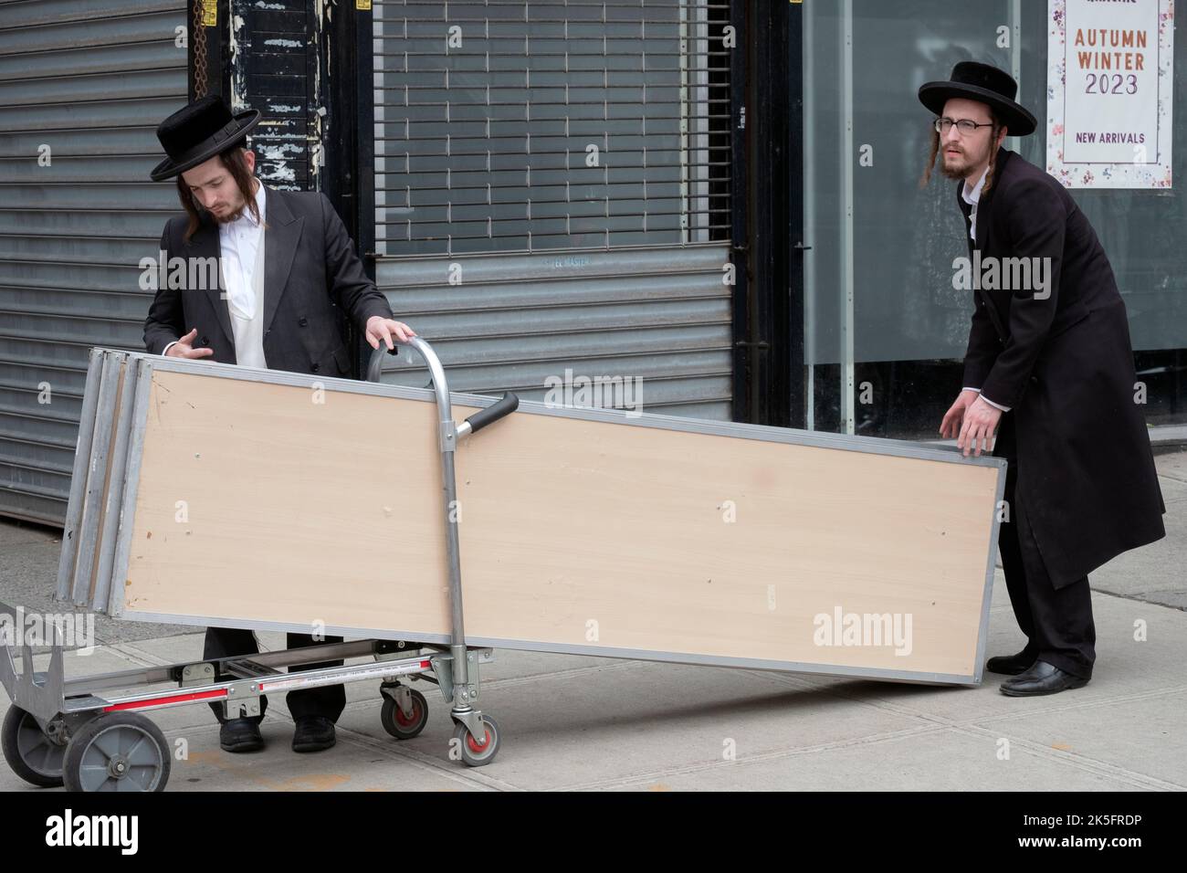 2 orthodox Jewish men transport building materials for their Sukkah in ...