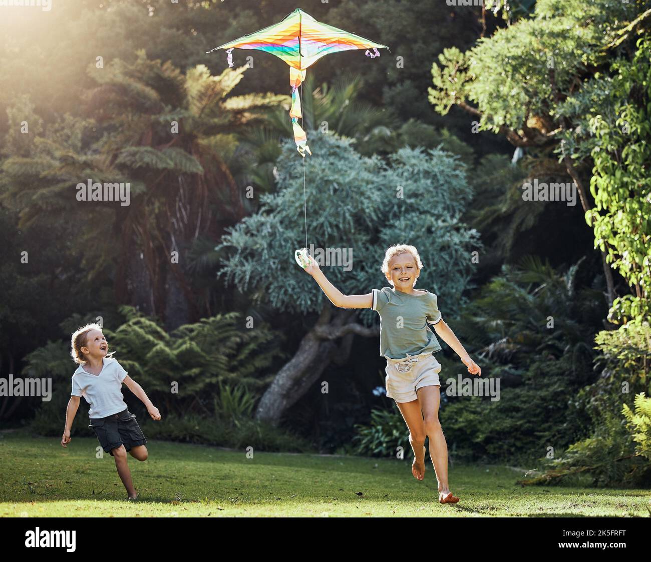 Nature, running and children flying a kite game enjoying summer ...