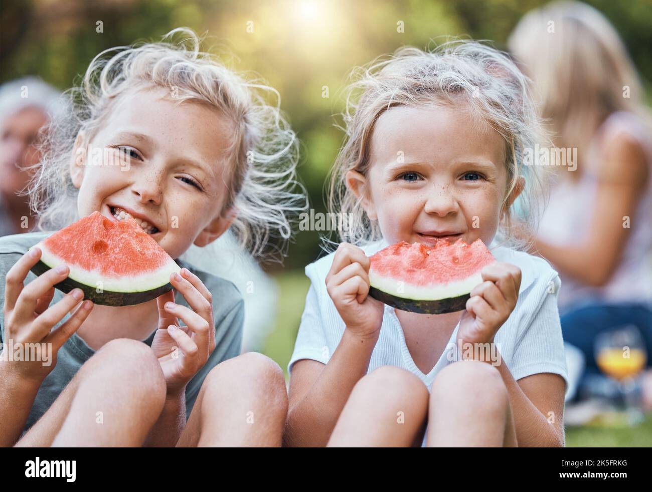 Children, watermelon and friends on a picnic in nature eating healthy ...
