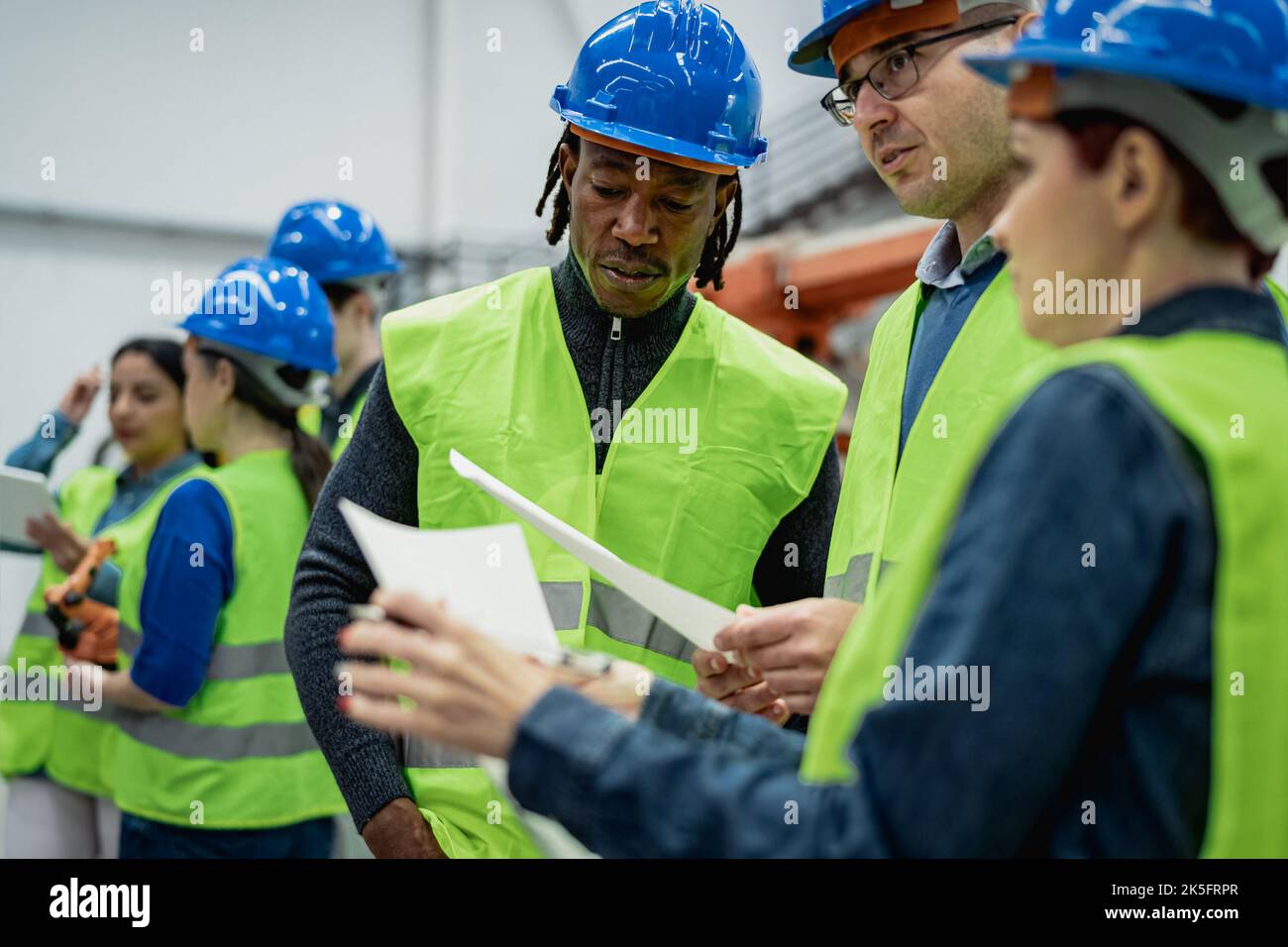 Team of multiracial engineers working in robotic factory - Tech ...