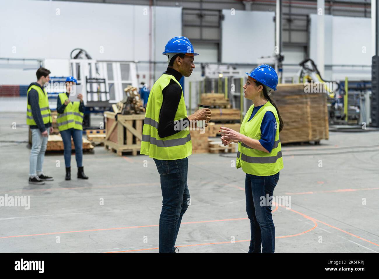 Team of multiracial engineers working in robotic factory - Tech ...
