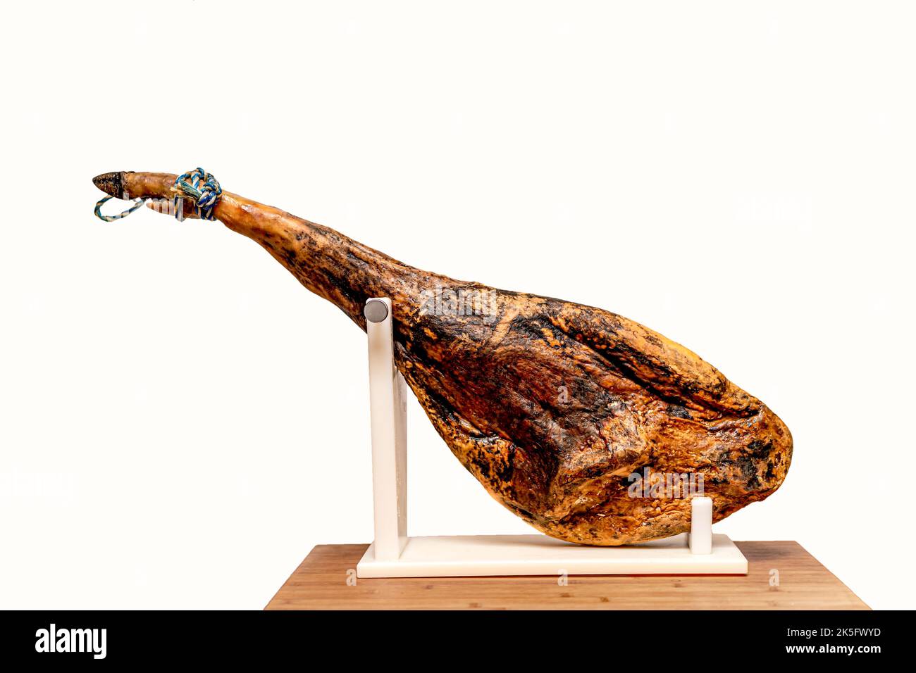 spanish iberico ham on ham holder on wooden table Stock Photo - Alamy