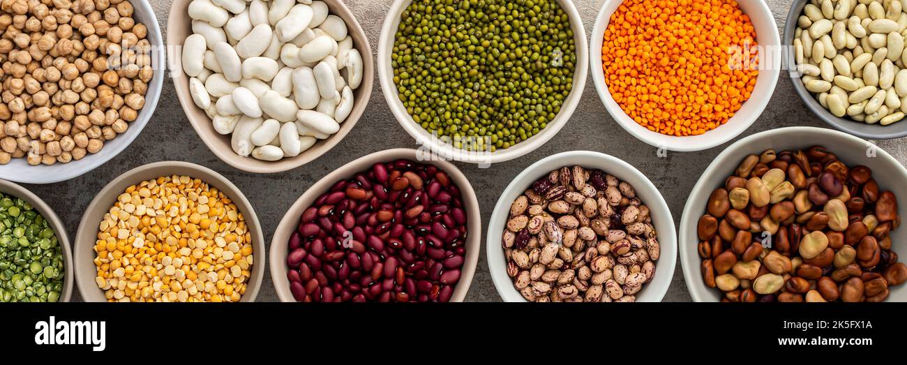 Banner of different types of legumes in bowls, yellow and green peas ...
