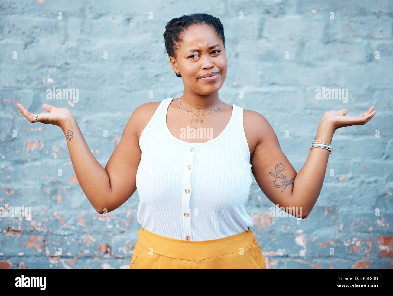 Portrait of confused black woman in doubt with a question and unsure ...