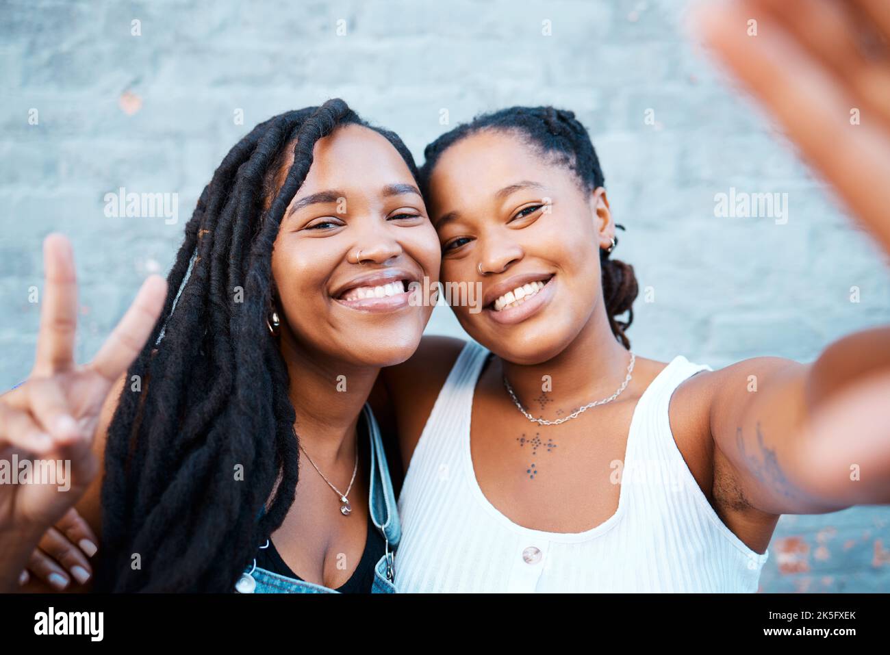 Smile, friends and selfie with black woman against wall with phone for ...