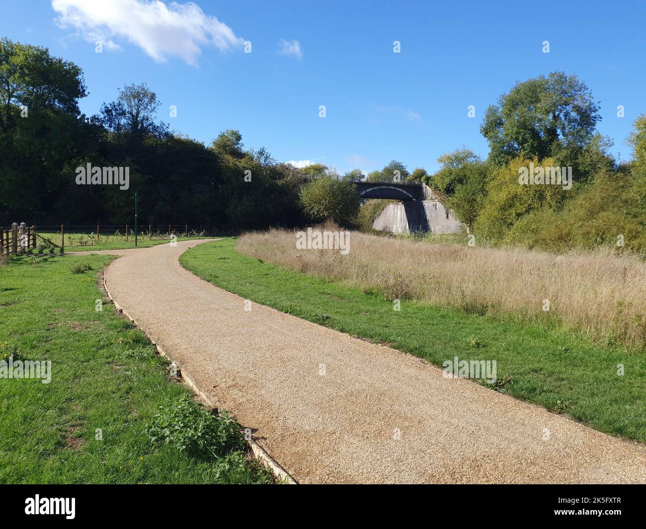 A scenic view of a gravel path going through a valley on a sunny day ...