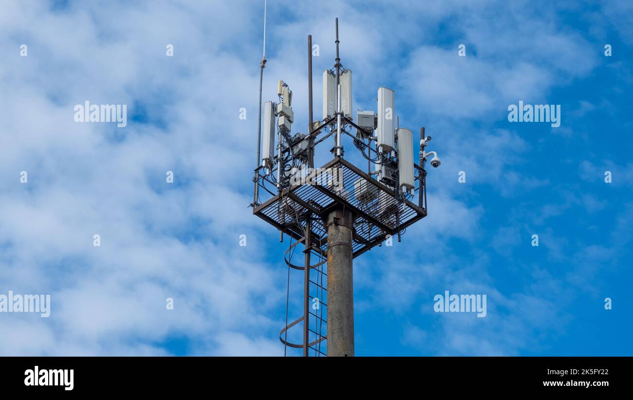 Modern tower 5 g on the background of a cloudy sky. Telecommunication antenna. Repeater ...