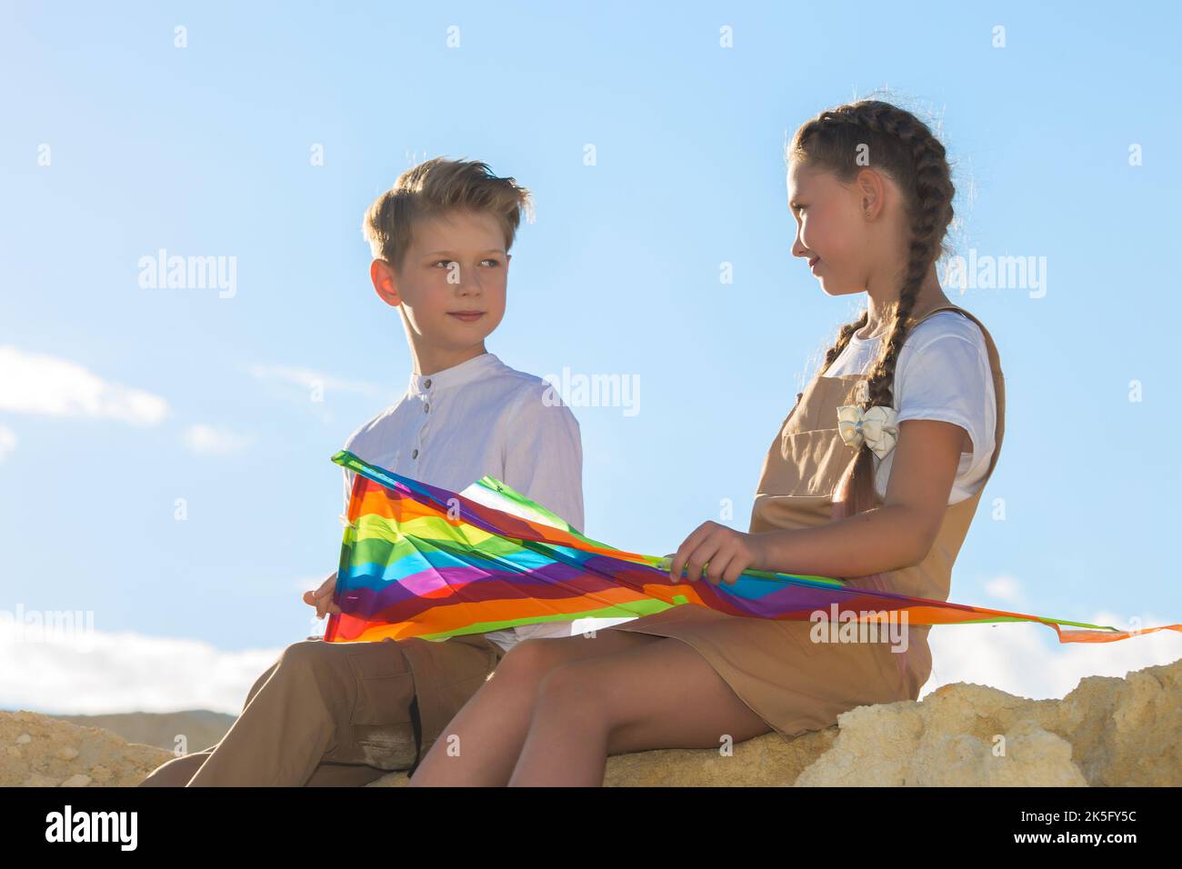 Teenage friends met nature, talking and collecting a kite Stock Photo ...