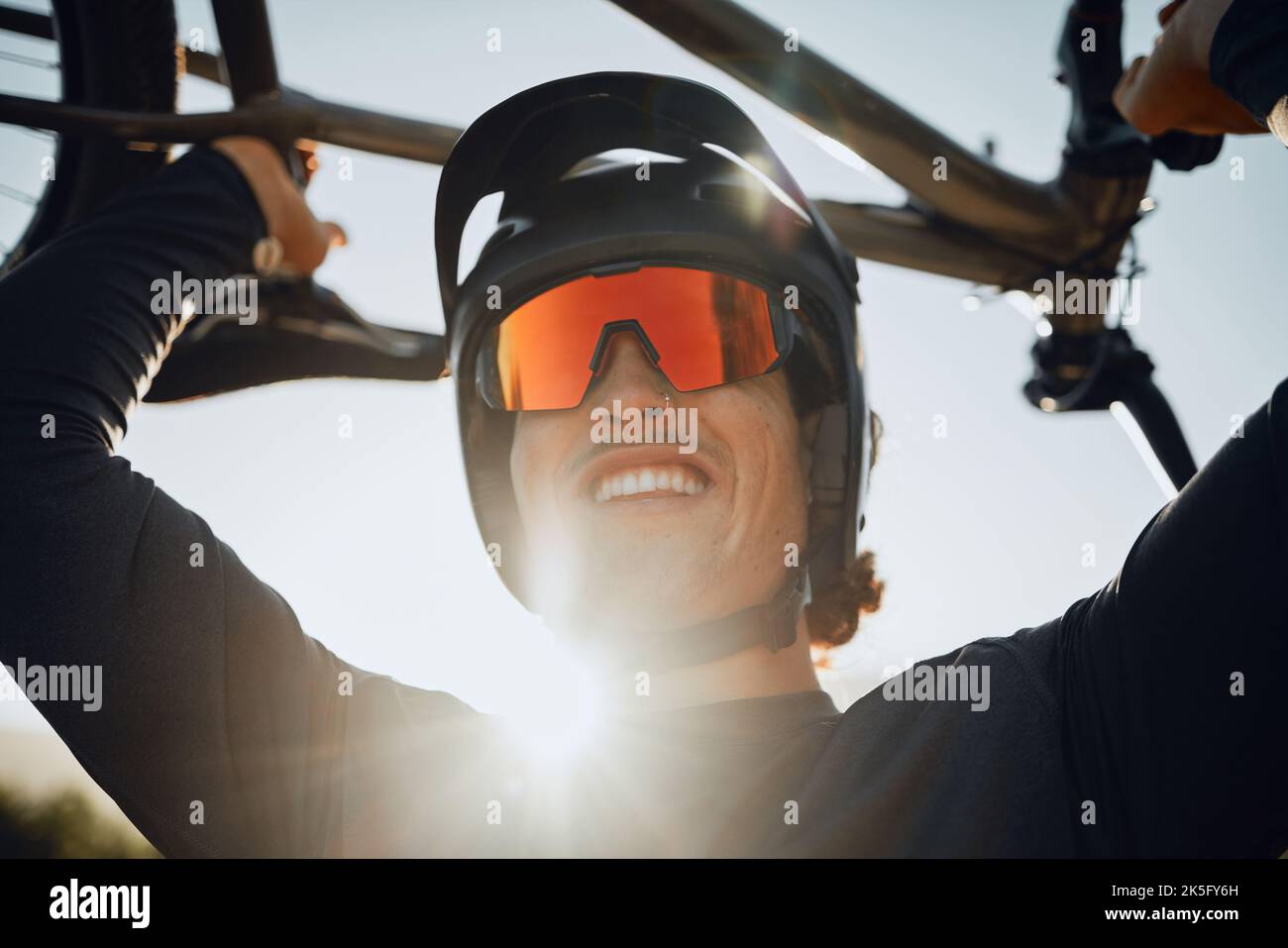 Cyclist, lift bike and smile for celebration after winning race, tour ...
