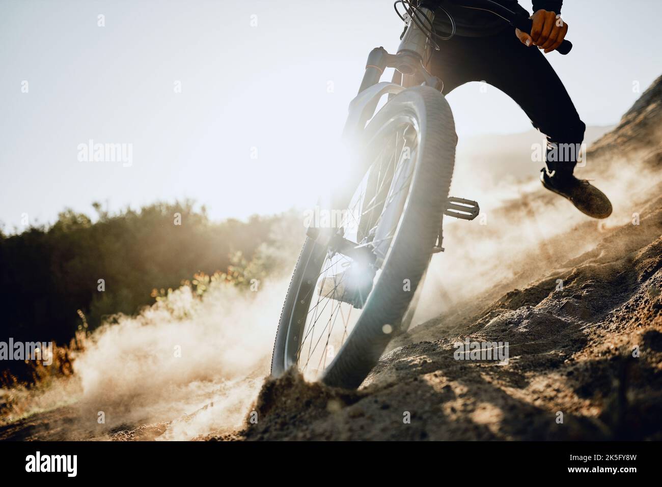 Action, mountain bike and man training in dirt, dust for sports ...