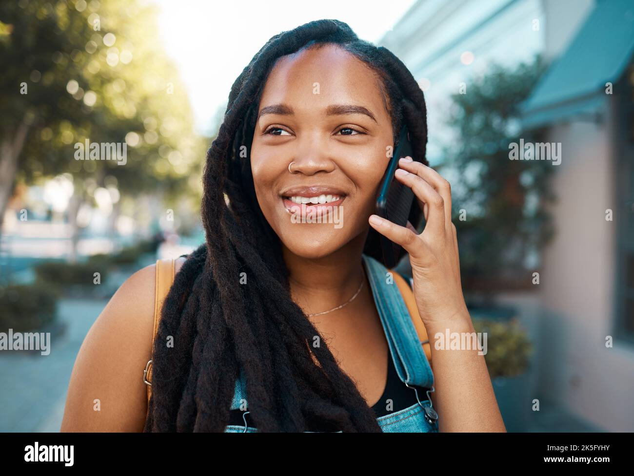 Happy black woman on the street, phone call on smartphone and talking ...