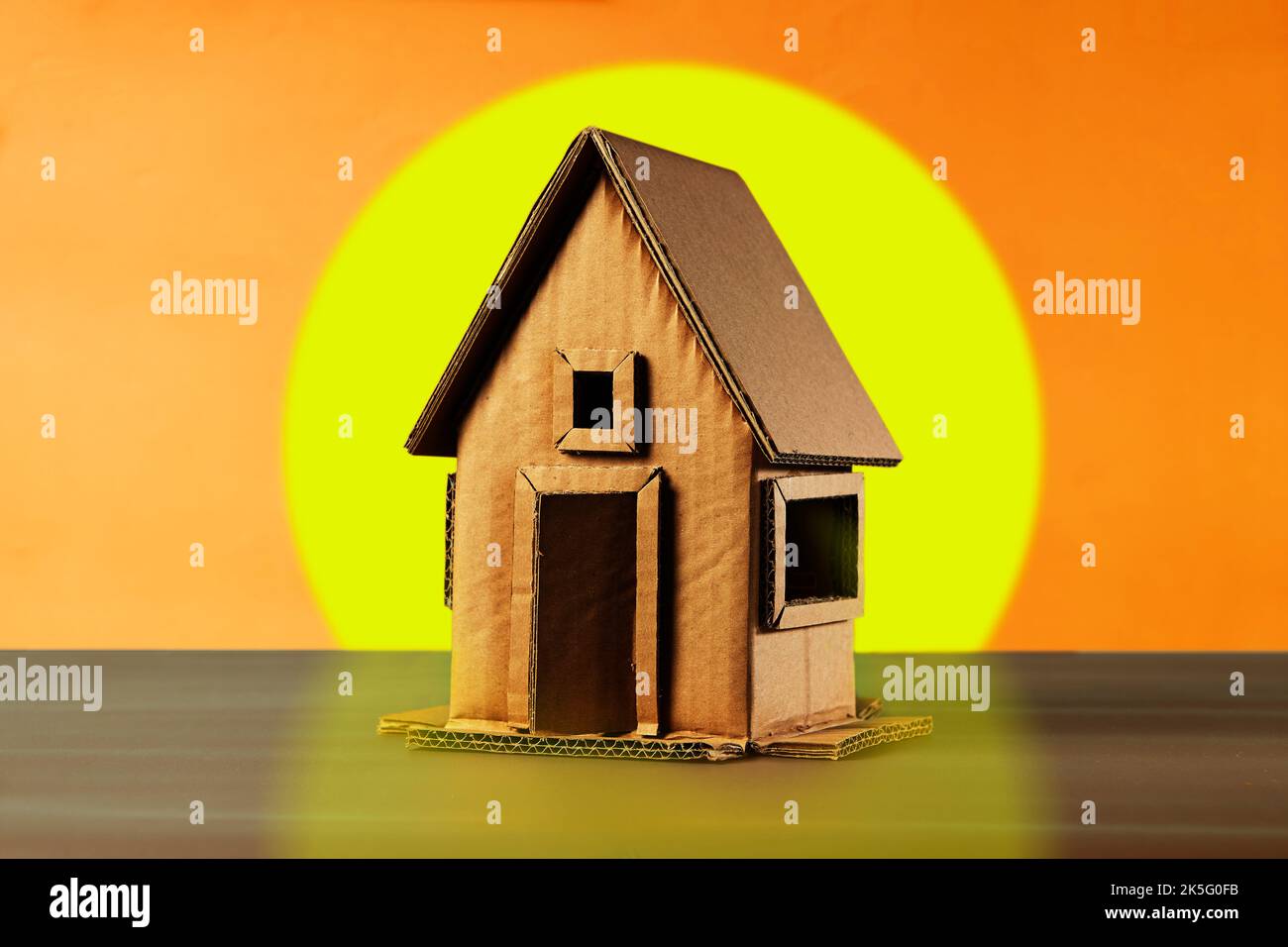 A cardboard house craft with a sunset illustration background Stock ...