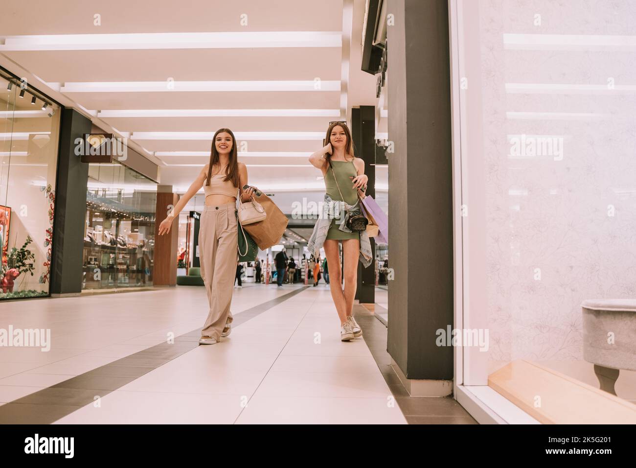 Two pretty girls walking at the mall Stock Photo - Alamy