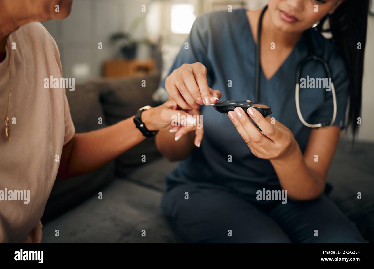 Diabetes, nurse and glucometer with patient in home checking blood ...