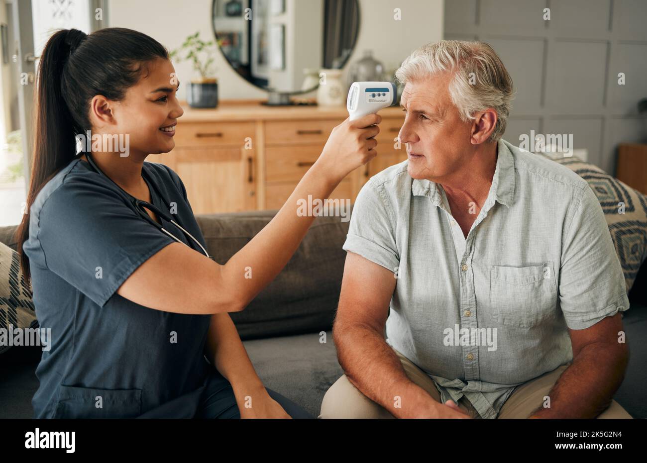 Covid, fever and thermometer with a nurse and patient in his home for a ...
