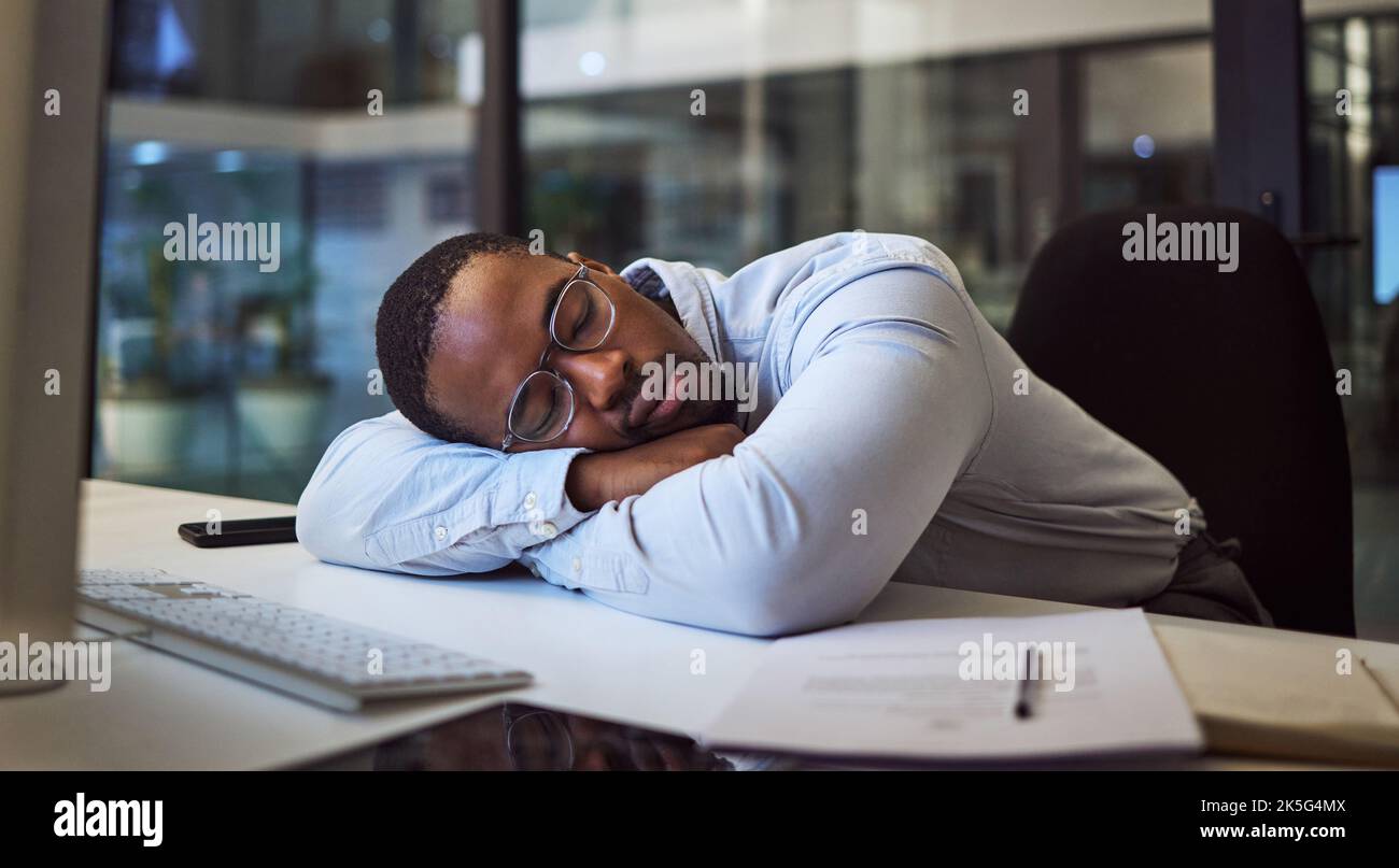 Black man in business, tired and sleeping on night office desk after ...