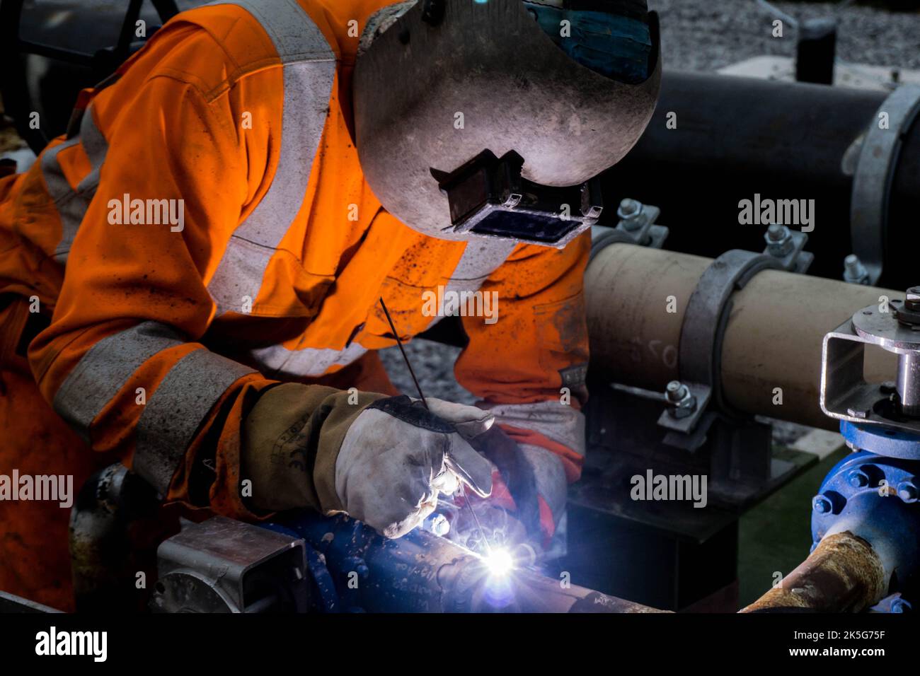 A person welding at a construction site Stock Photo - Alamy