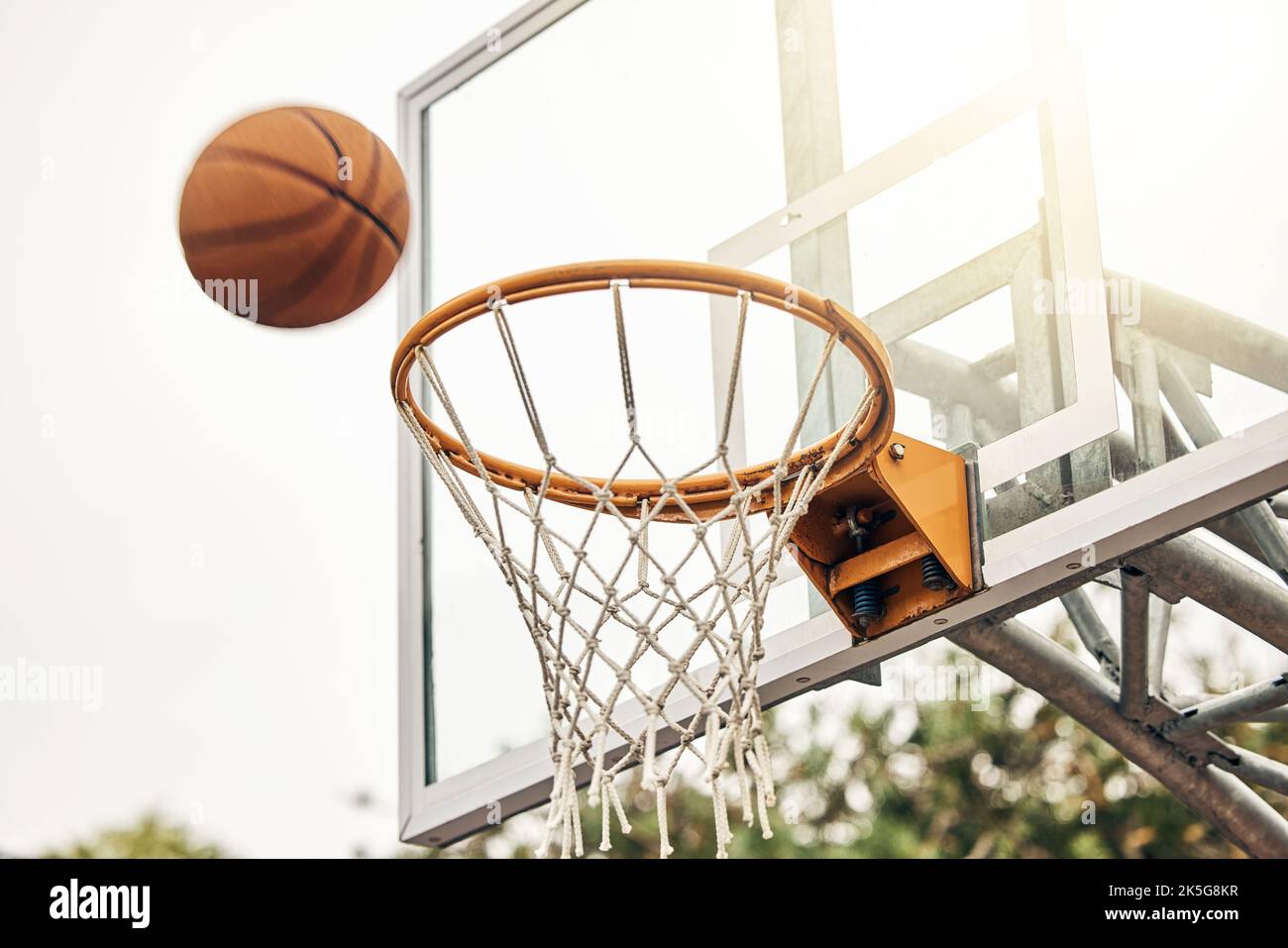 Basketball, net and ball flight in sports game outdoors for match in ...