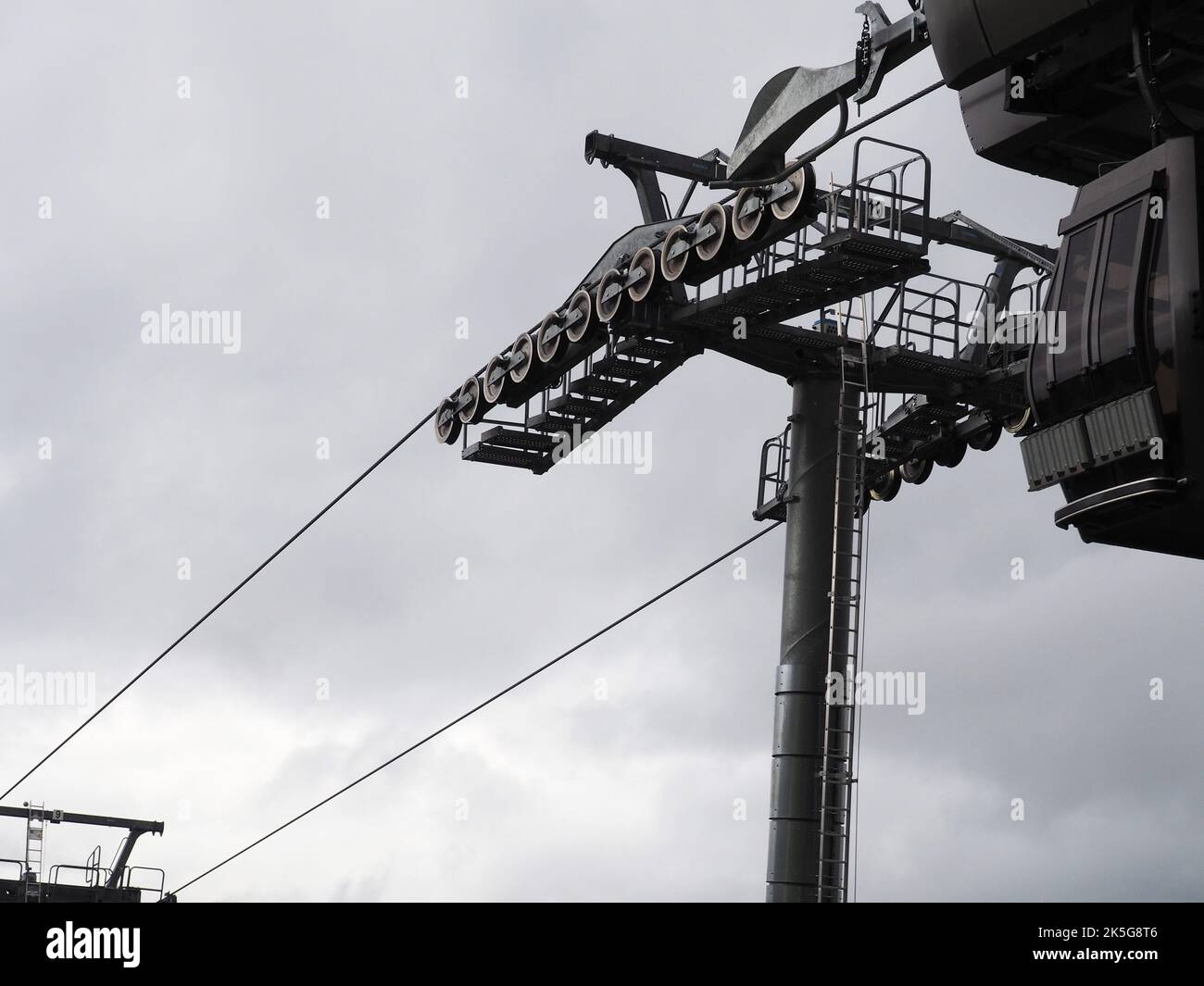 A crosshead cableway support with metal cantilever arms and rollers ...