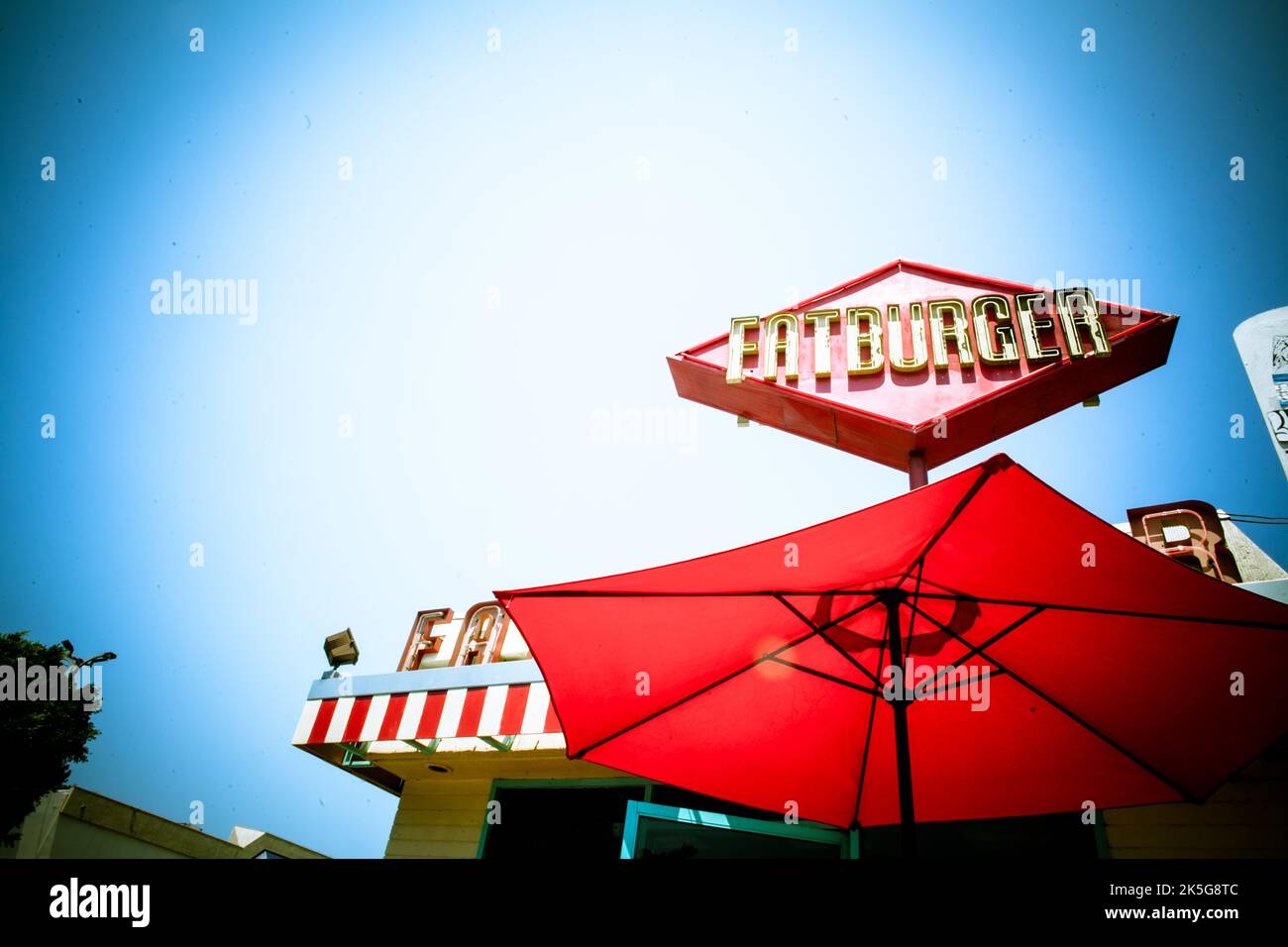 A low angle shot of the sign on Fat Burger restaurant against the sky ...