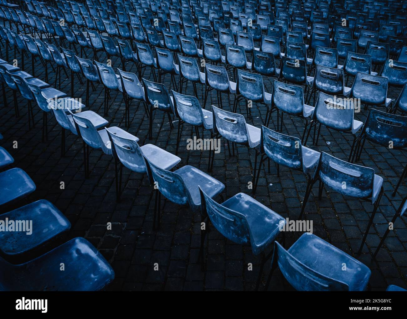 A row lines of plastic blue chairs Stock Photo - Alamy