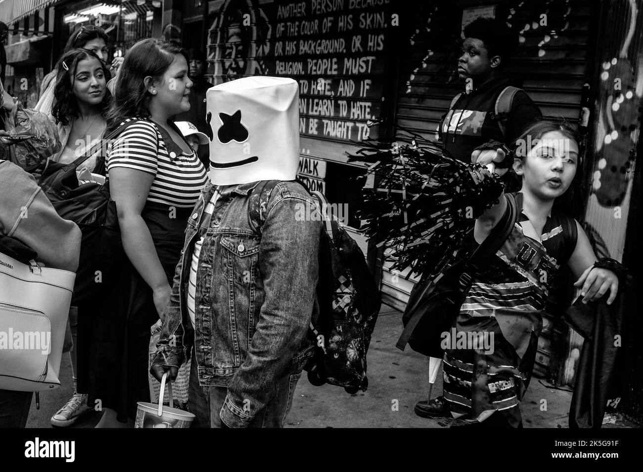 A grayscale shot of a guy wearing Marshmallow mask for Halloween ...