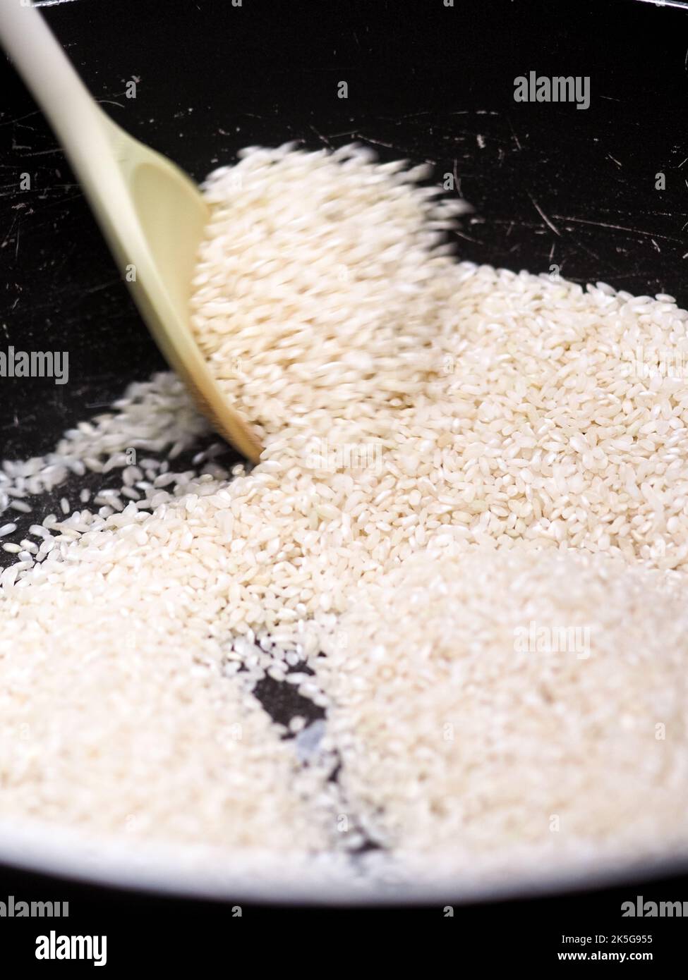 carnaroli rice grain mixing in the pan for risotto Stock Photo - Alamy