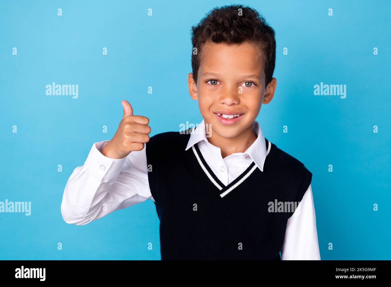 Portrait of cheerful friendly boy hand finger demonstrate thumb up ...