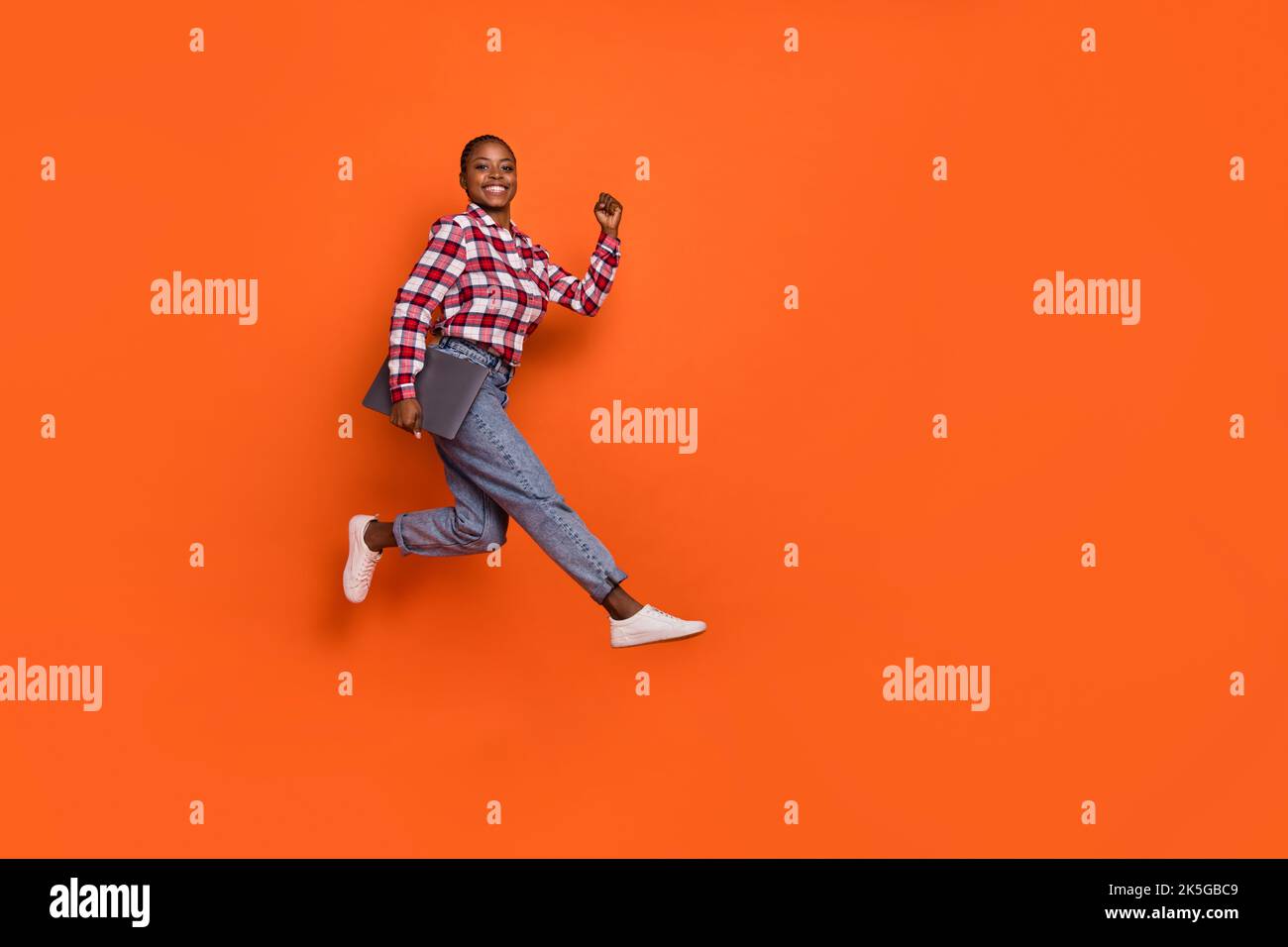 Full size portrait of active overjoyed lady rush fast hold wireless ...