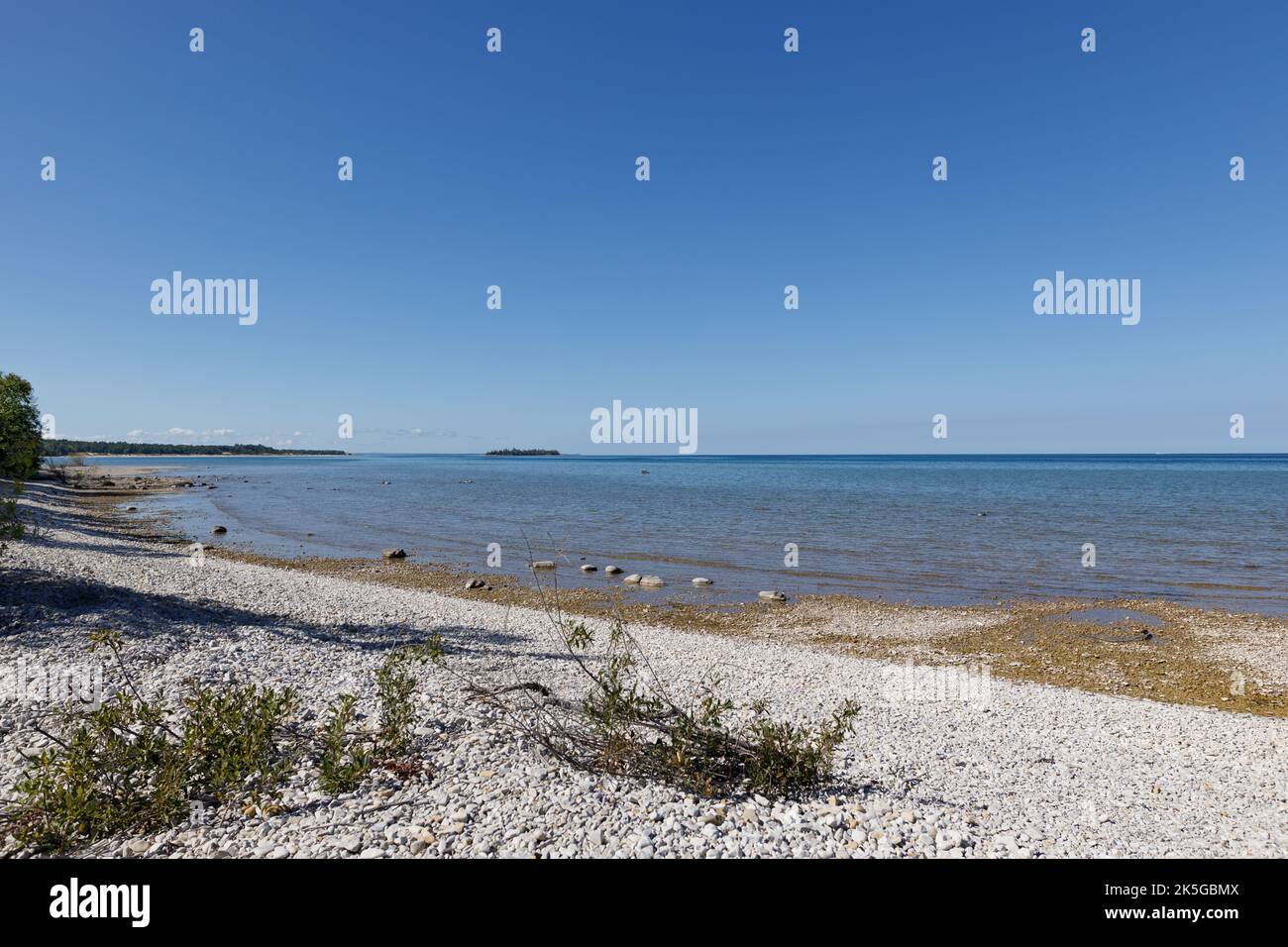 A scenic view of the shore of a beach with a beautiful seascape in the ...