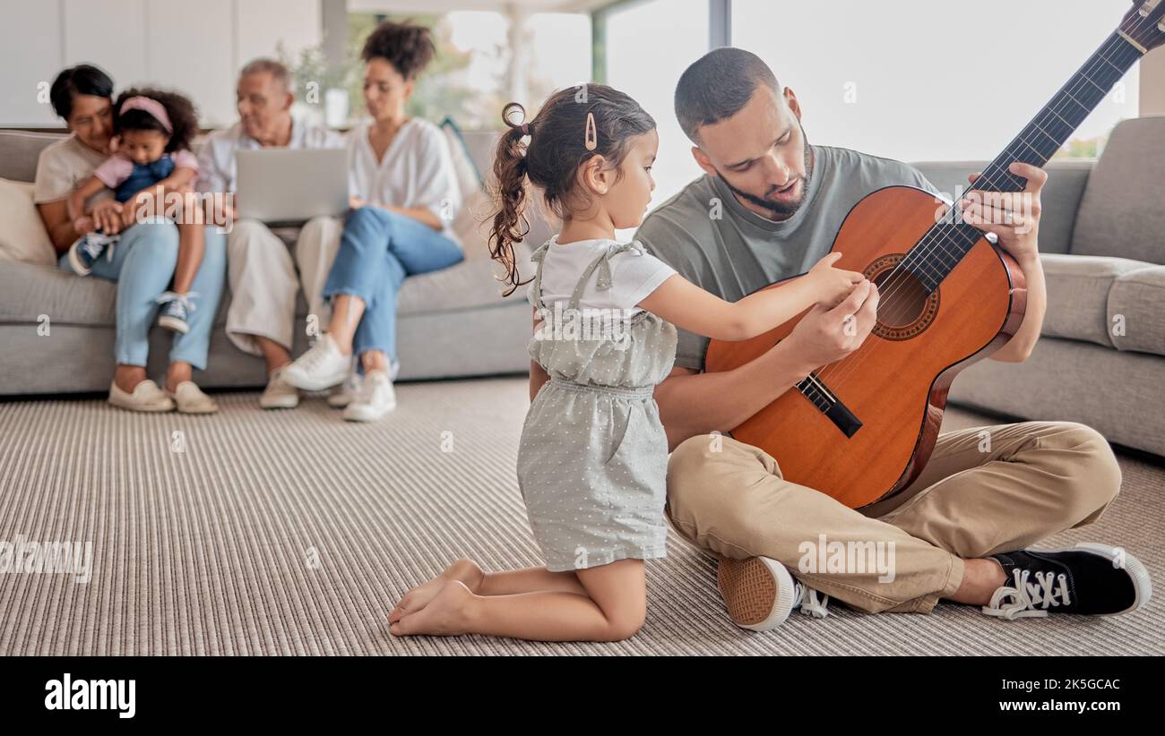 Father, child and guitar teaching, learning or music in the living room ...