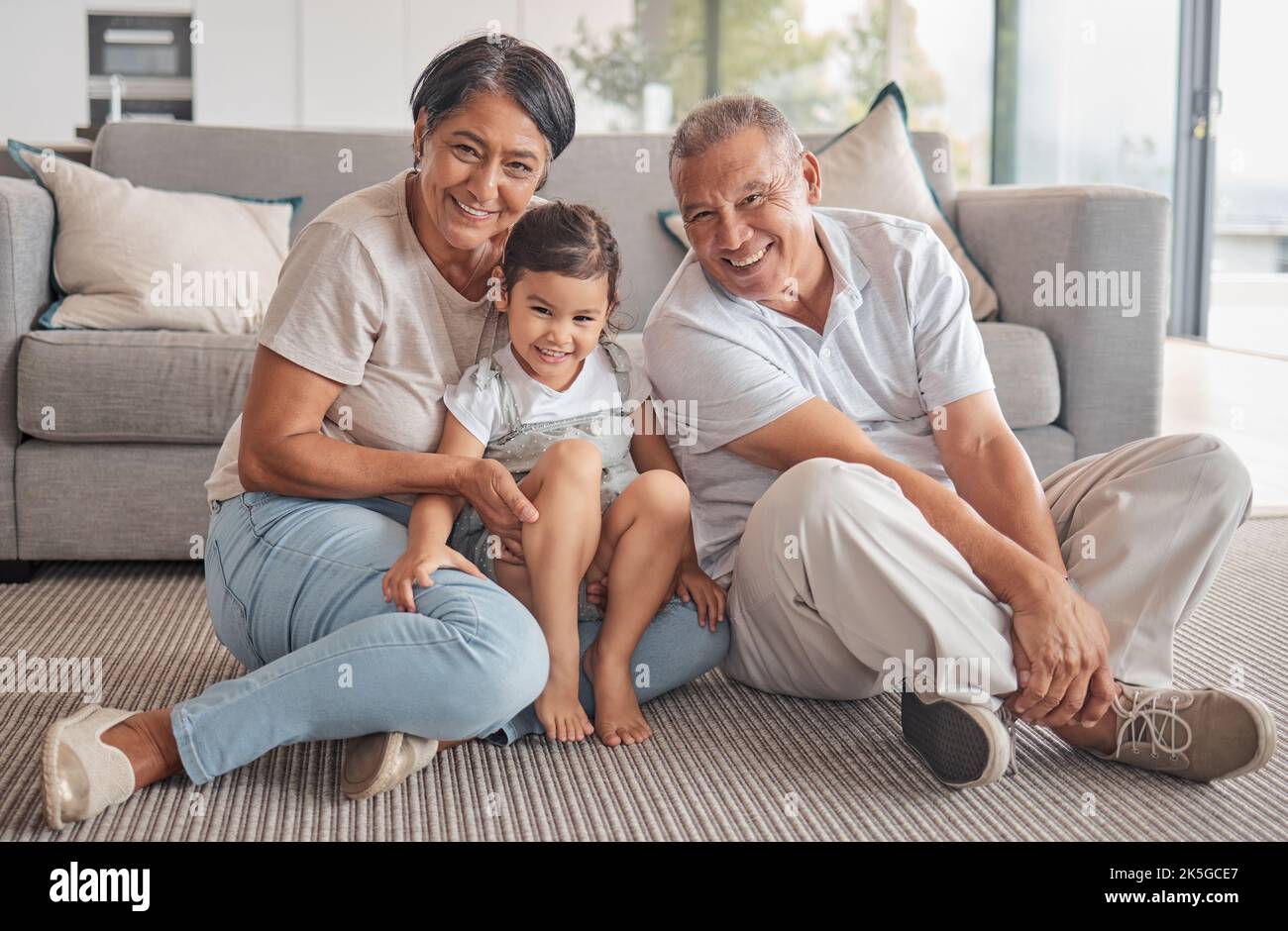 Girl, hug and grandparents with love, care and relax in family home ...