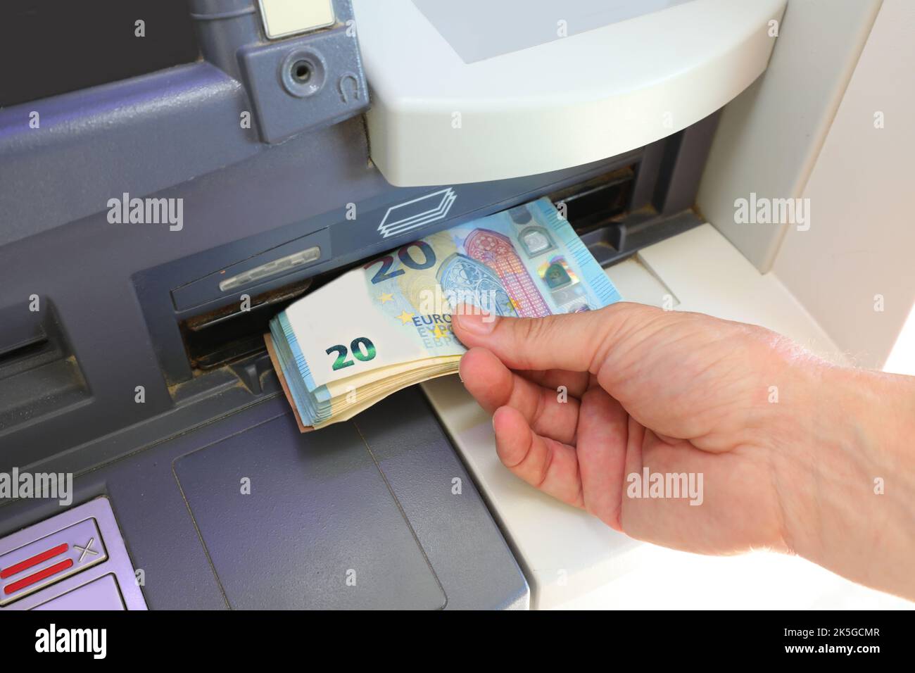 person who picks up european Euro 20 bills in a bank ATM machine Stock ...