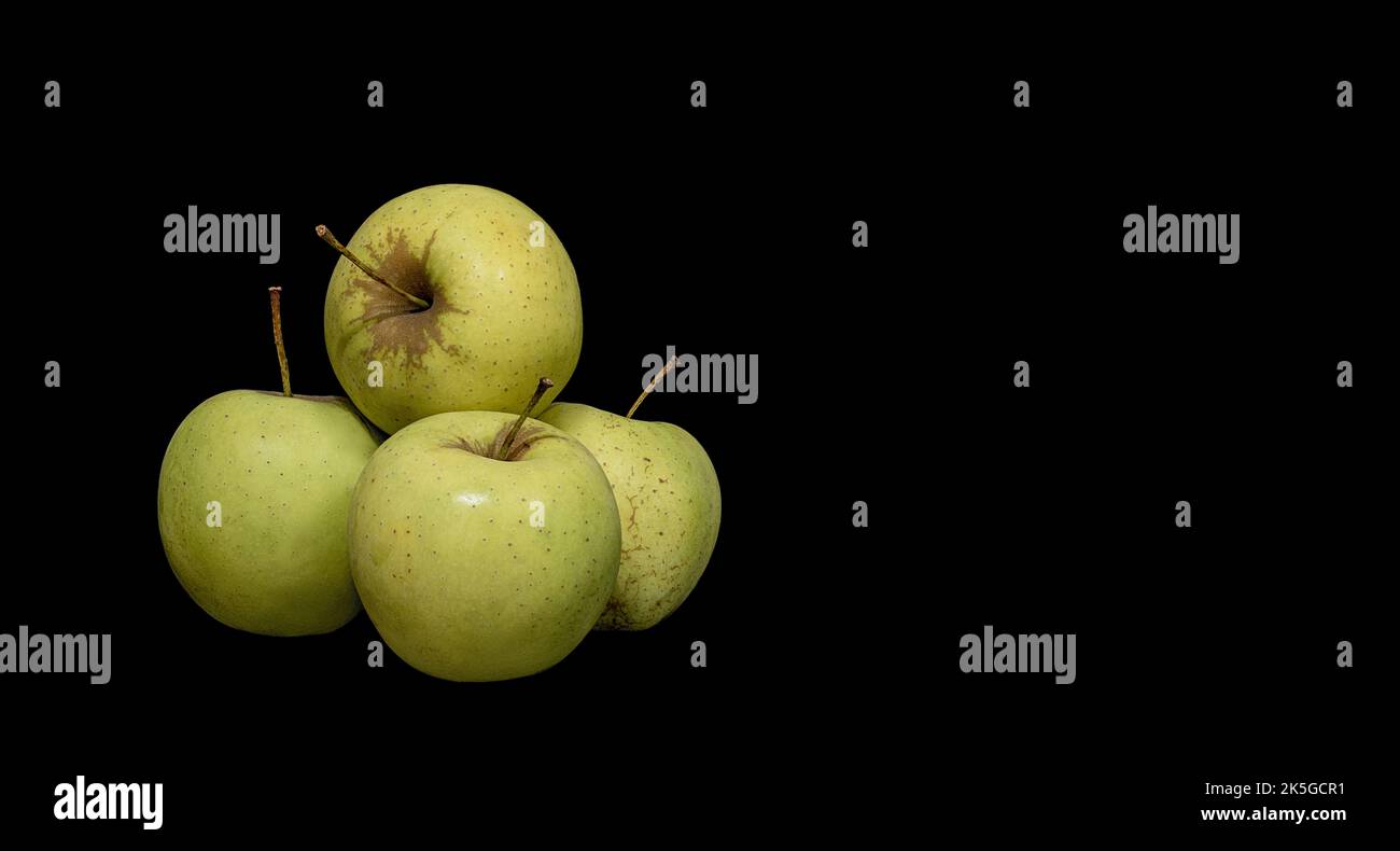 Image of a pyramid of ripe green apples on a black background Stock ...