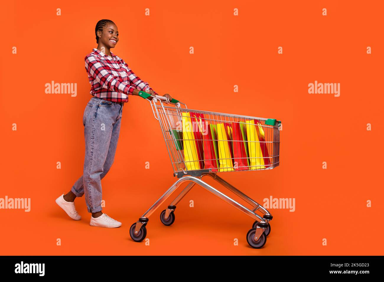 Full body portrait of cheerful nice lady push trolley look empty space ...