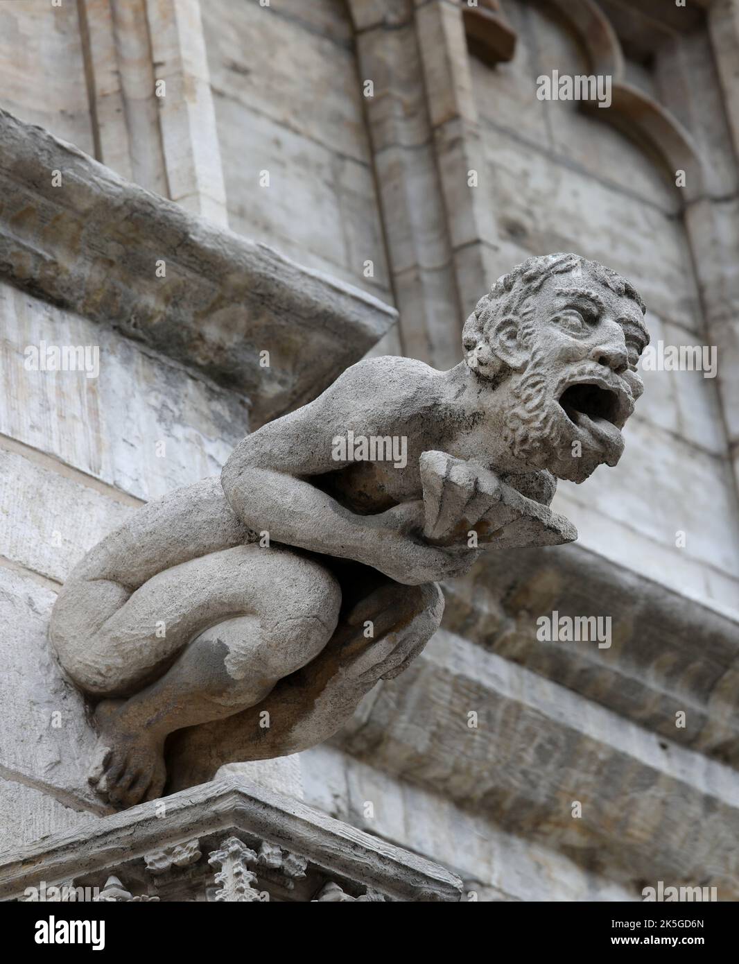 Monstrous statue with almost human features called gargoyle on the ...