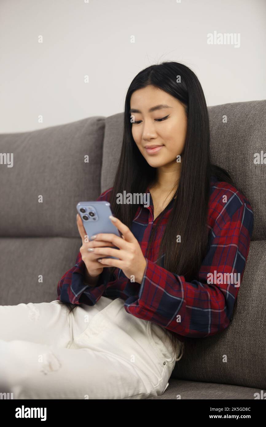 Cute asian girl browsing mobile app. Cheerful Vietnamese female person ...