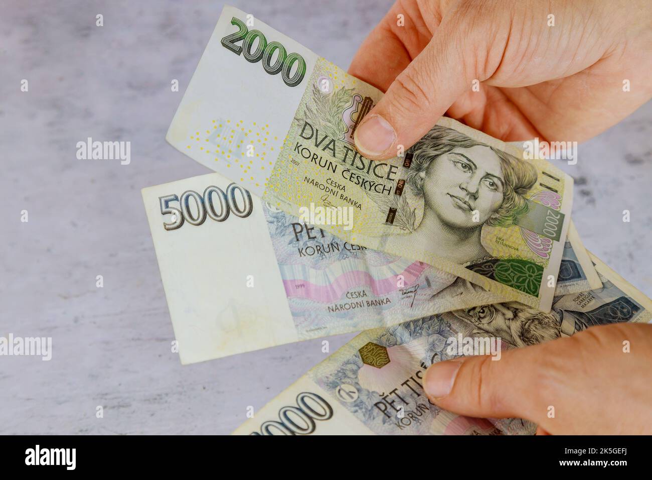 Czech Republic banknotes with man holding Czech koruna CZK bill ...