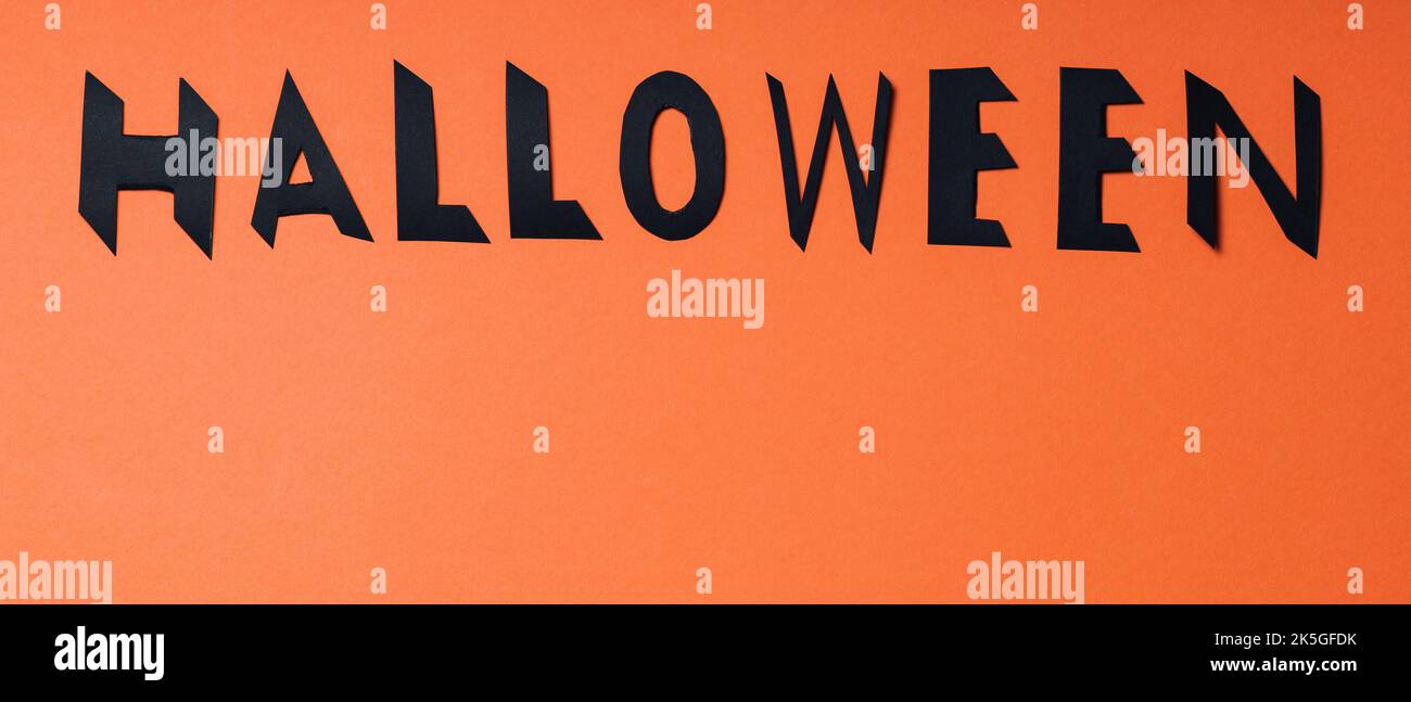Halloween lettering with black letters on an orange background ...