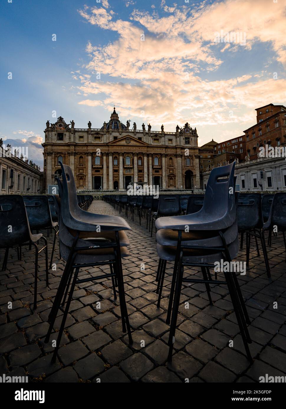 A vertical shot of chairs in front of Saint Peter's Basilica in Rome ...