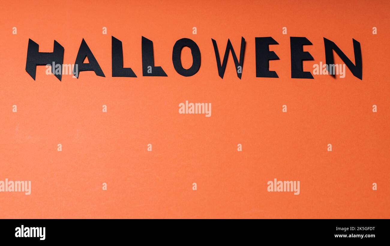 Halloween lettering with black letters on an orange background ...