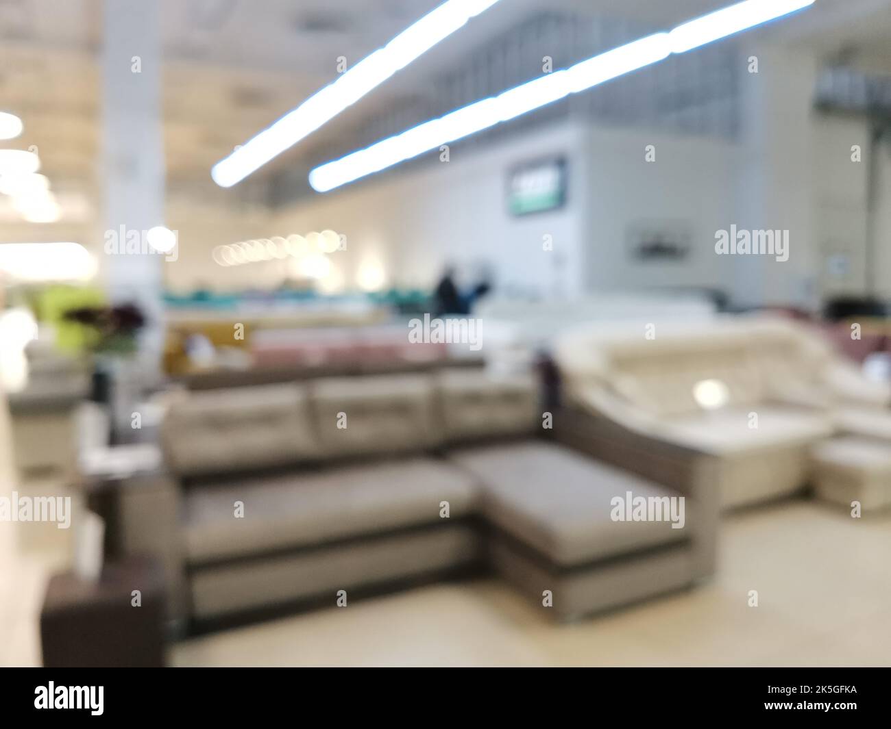 Abstract blur sofa in home decor furniture showroom store interior with ...