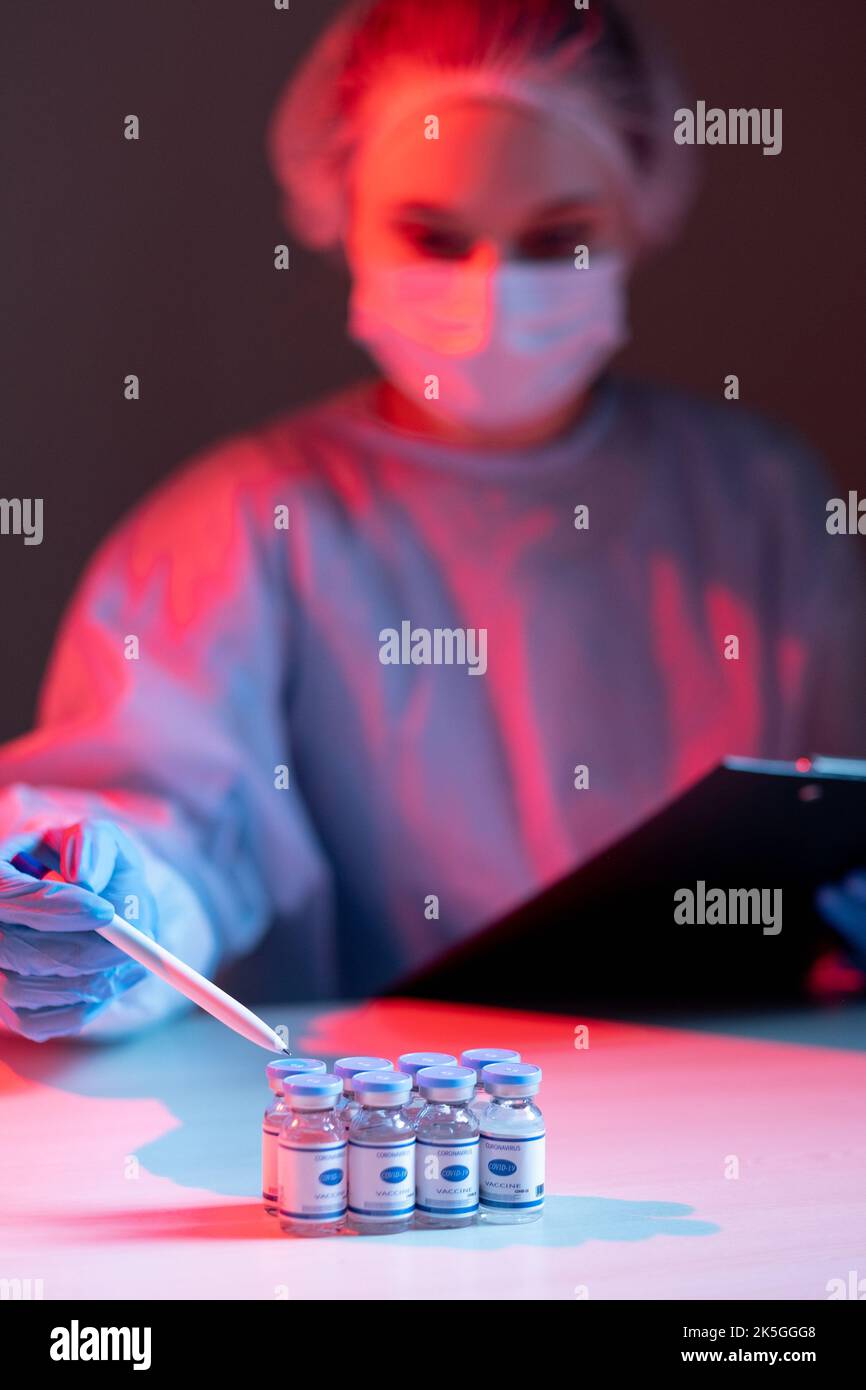 Vaccine report. Covid-19 immunization. Medication record. Female nurse ...