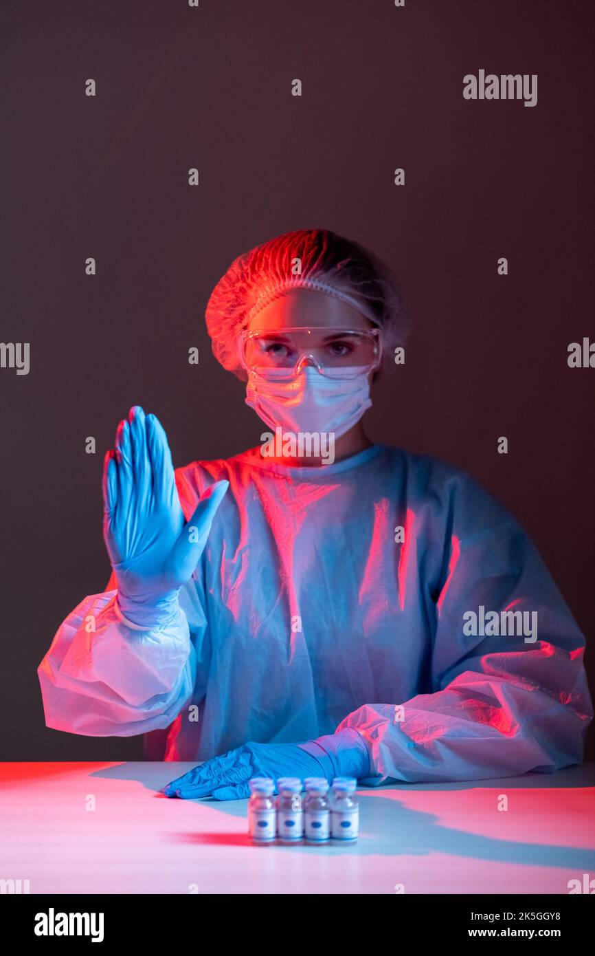 Vaccine risk. Stop covid-19. Safety warning. Female doctor in ppe face ...