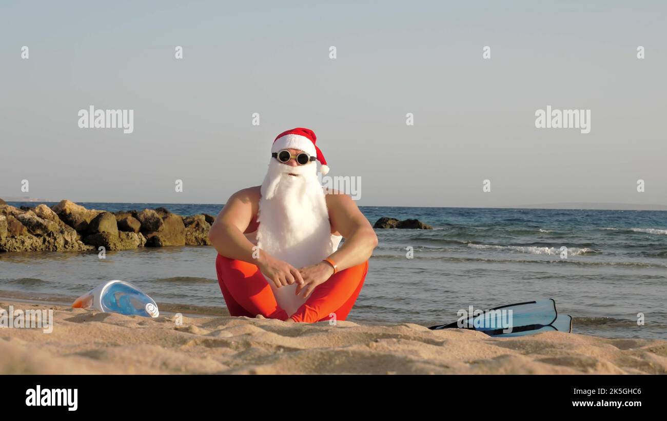 Santa Claus summer vacation. Father Christmas having fun. Santa doing ...