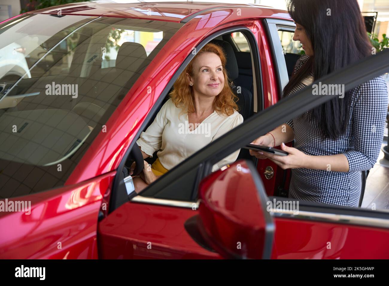 Manager And Client Car Dealership Are Discussing Purchase Car On Lease manager-and-client-car-dealership-are-discussing-purchase-car-on-lease