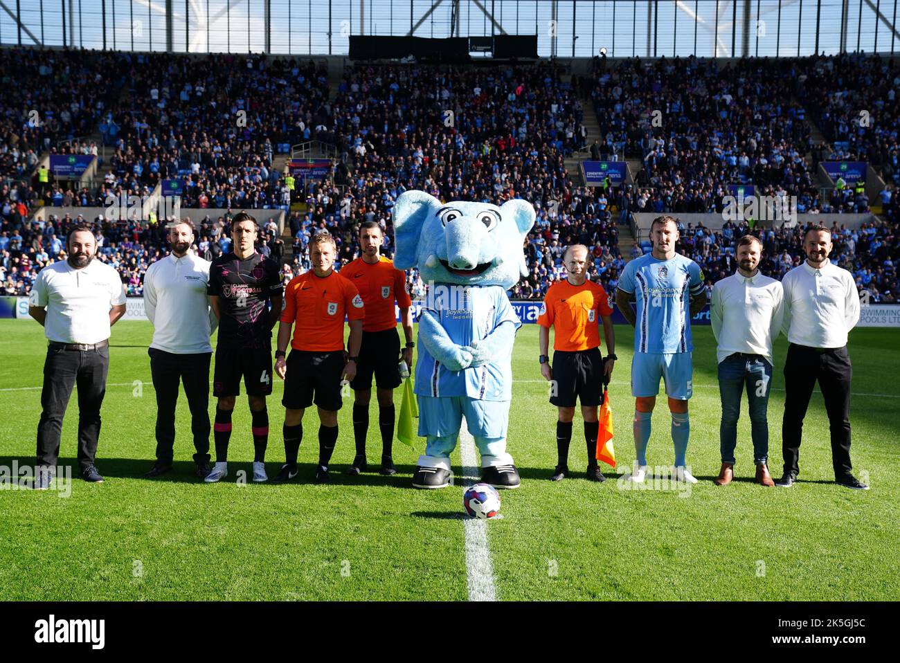 Coventry City mascot Sky Blue Sam poses with the match day sponsors ...
