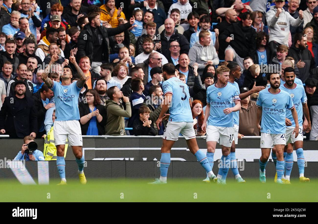 Manchester City's Joao Cancelo (left) celebrates scoring their side's ...