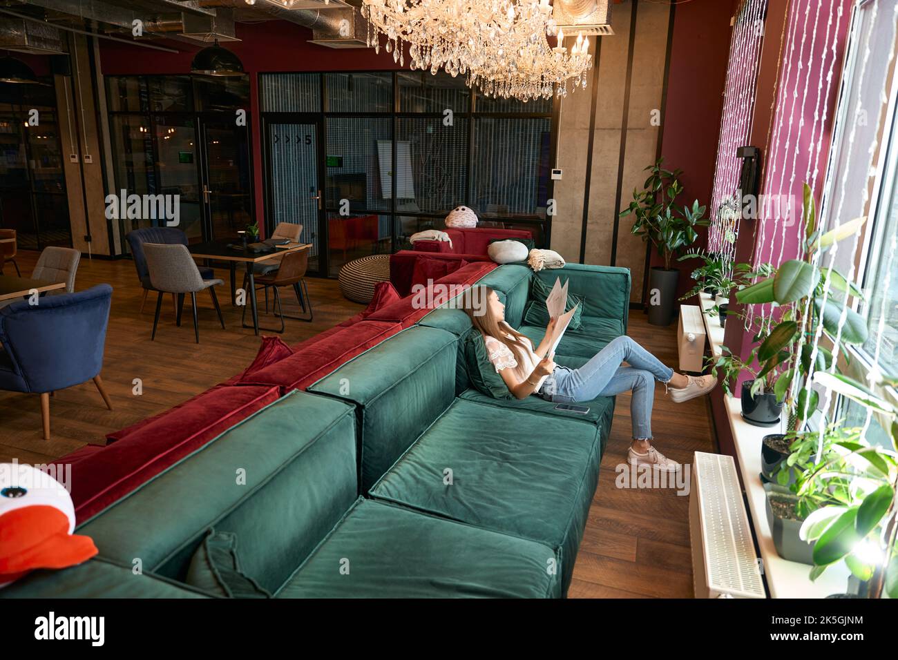 Young female looking through documents in her hands Stock Photo - Alamy